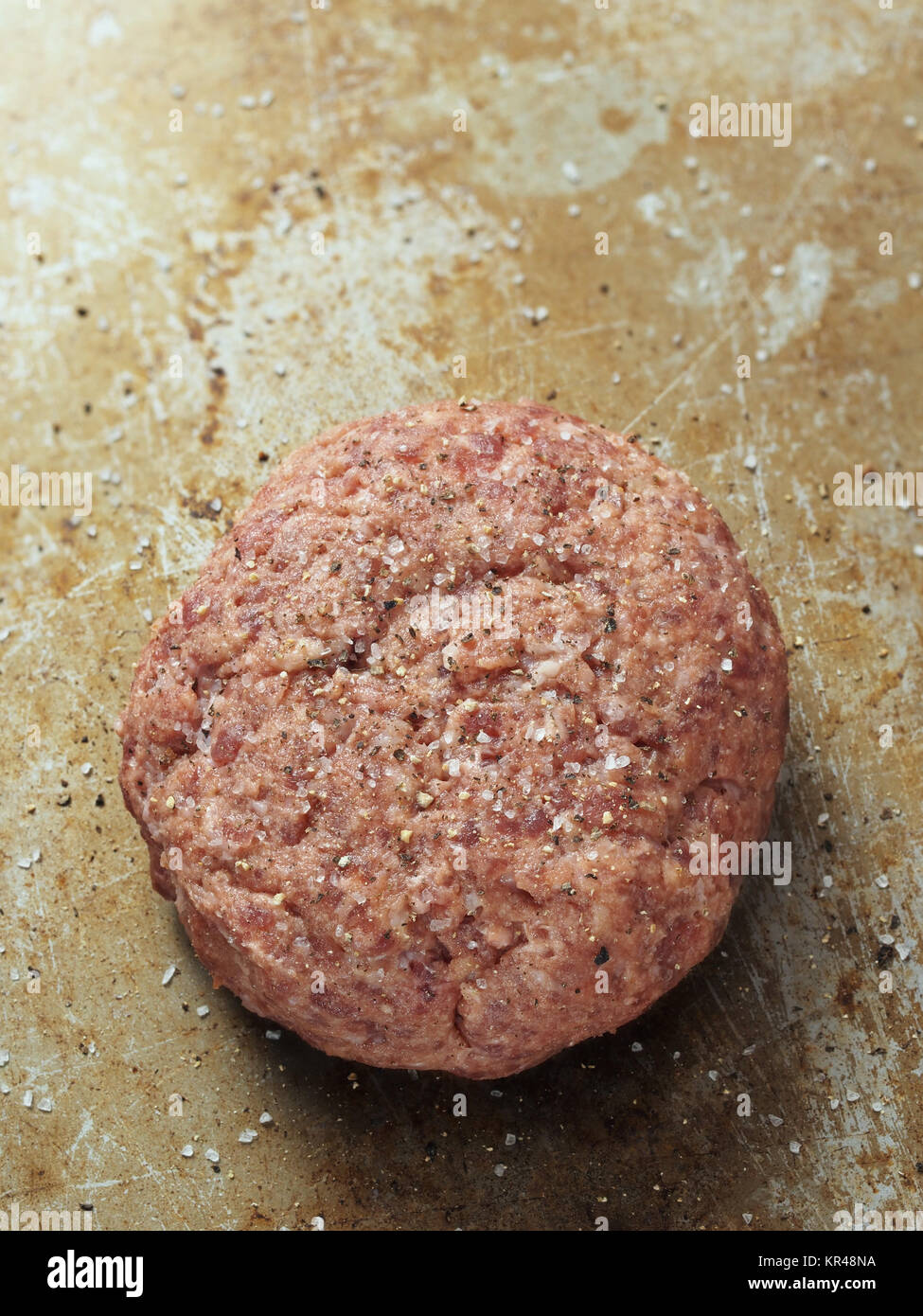 rustic uncooked seasoned hamburger patty Stock Photo - Alamy