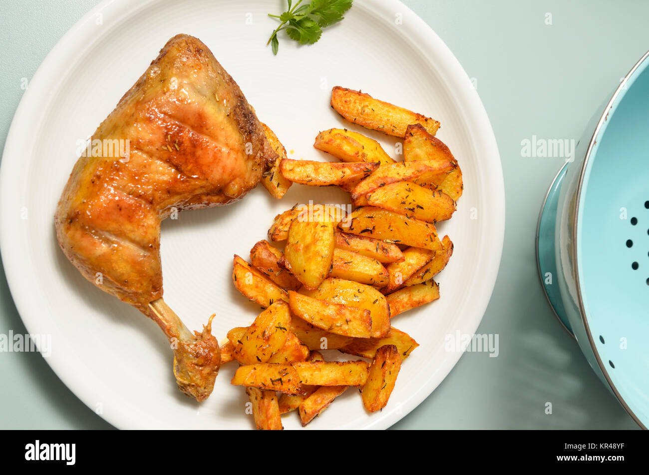 Roasted chicken with potato wedges on a plate Stock Photo - Alamy