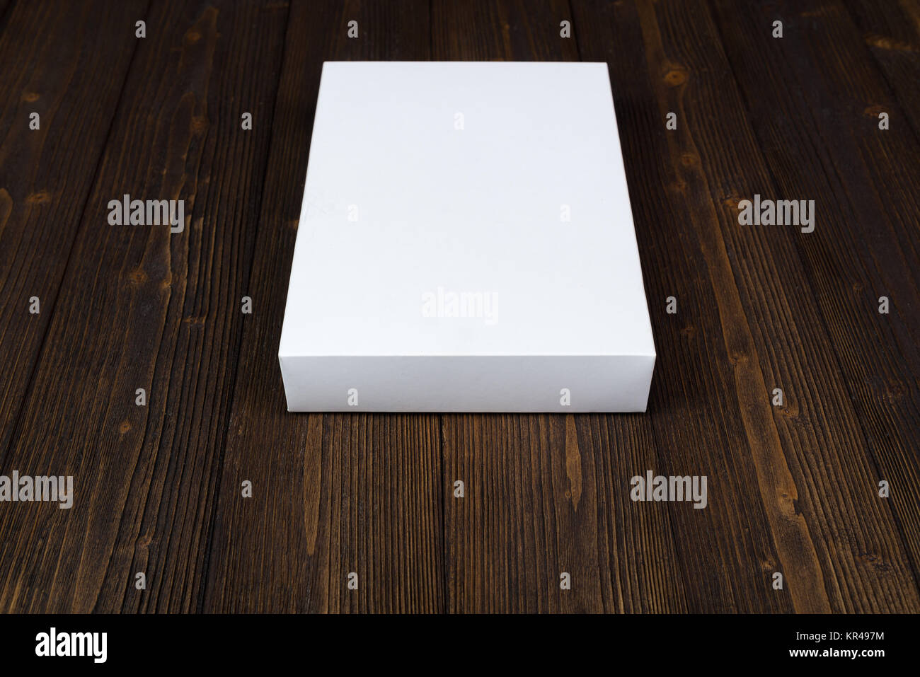 Empty white gift box or tray for mock up on dark wooden table with copy ...