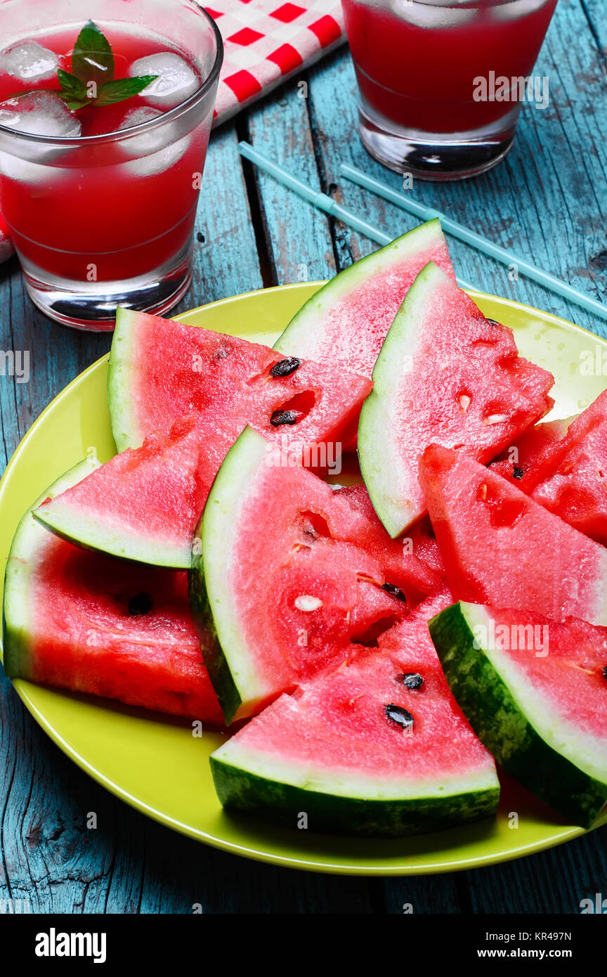 Fresh fruit of summer watermelon cut into lobes on plate on bright ...