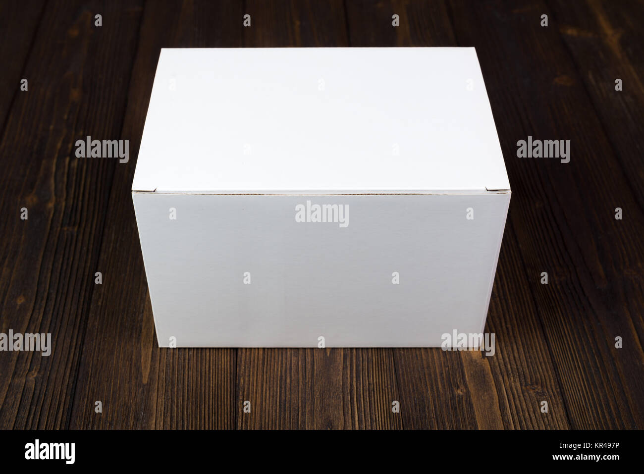 Empty white gift box or tray for mock up on dark wooden table with copy ...