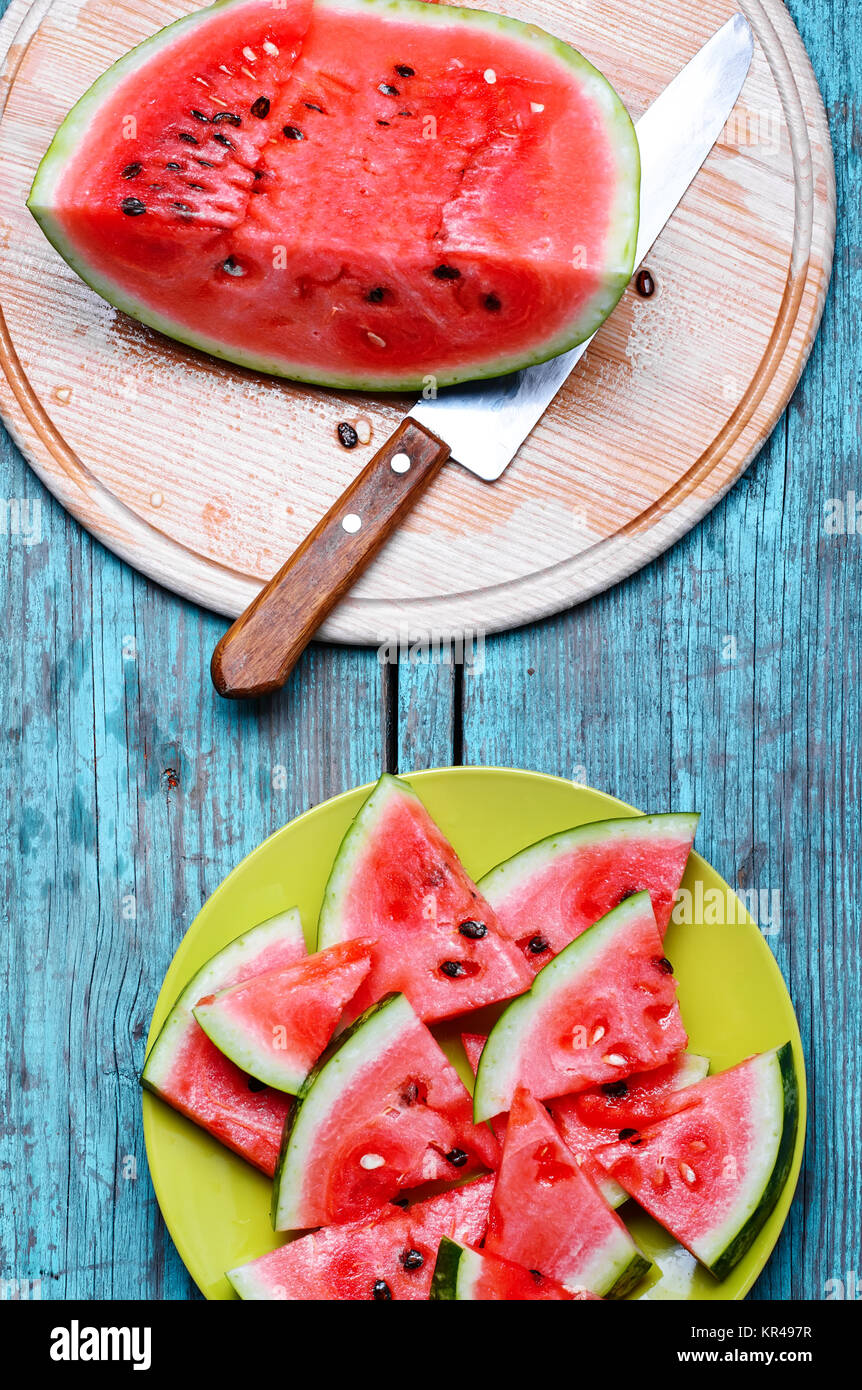 Fresh fruit of summer watermelon cut into lobes on plate on bright ...