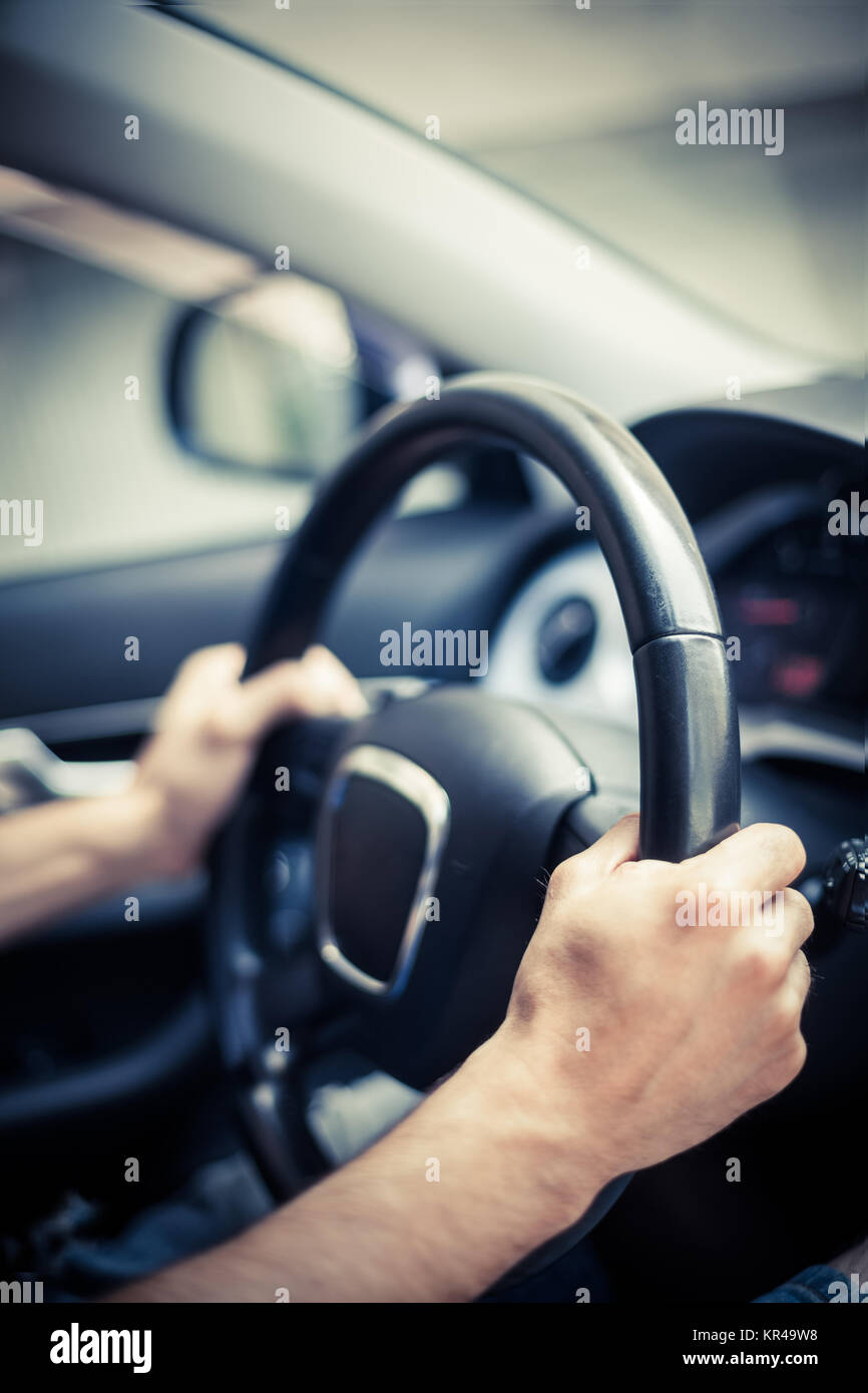 Hands on steering wheel Stock Photo - Alamy