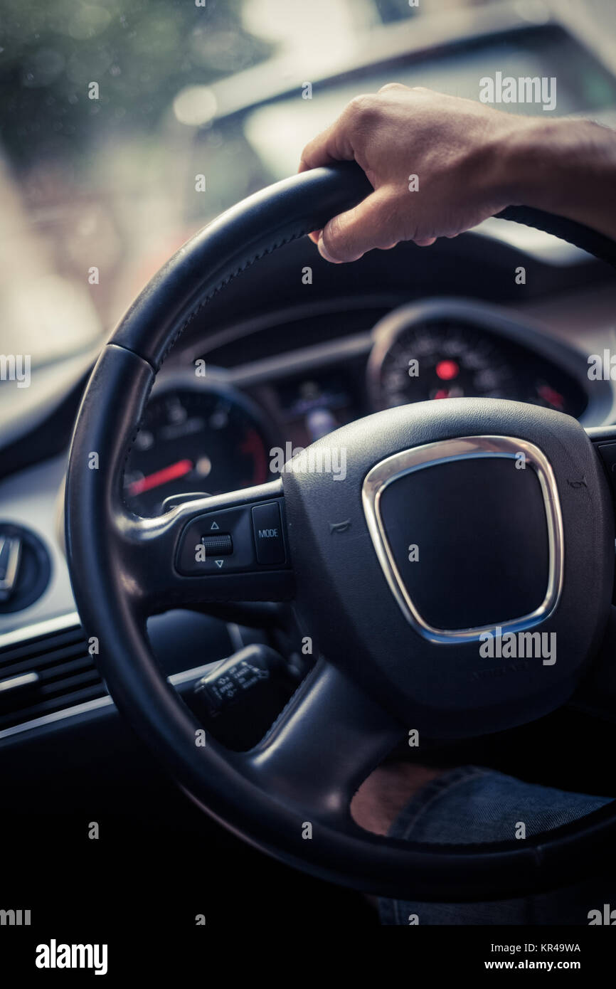 Hands on steering wheel Stock Photo - Alamy