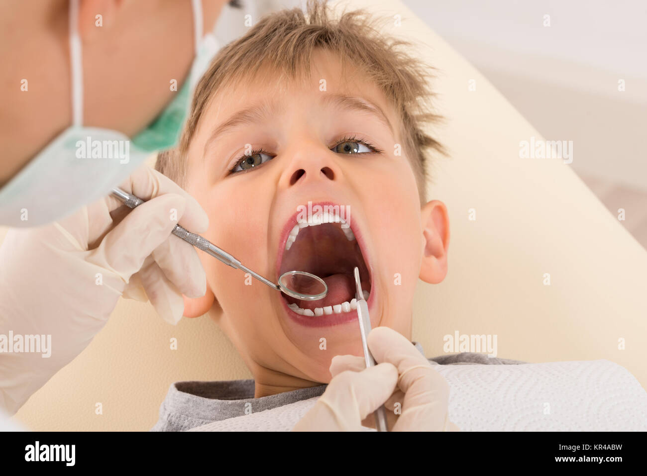 Dentist's Hand Examining Teeth Of Child Patient Stock Photo - Alamy