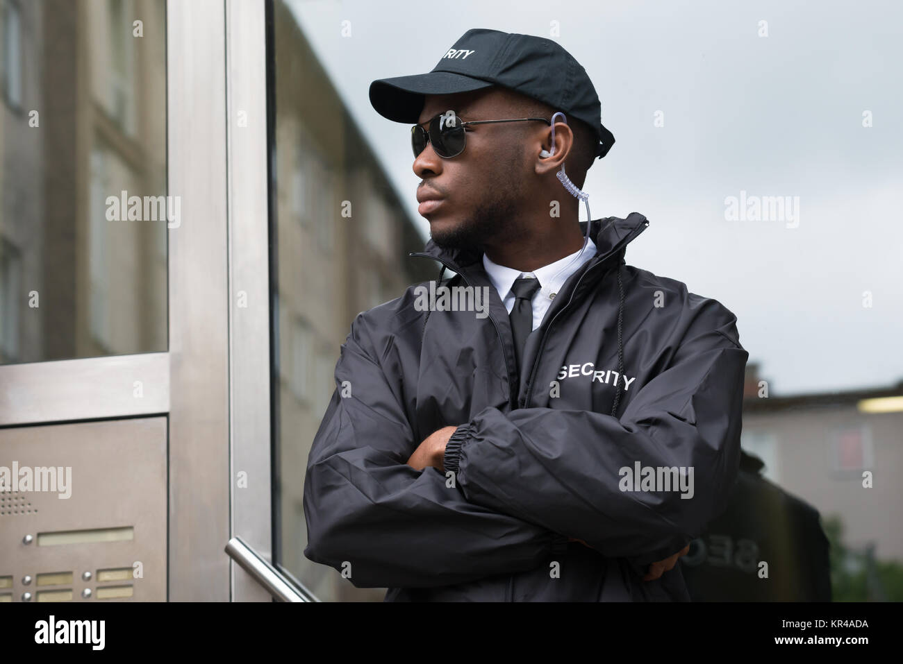Security Guard Standing Arms Crossed Stock Photo - Alamy