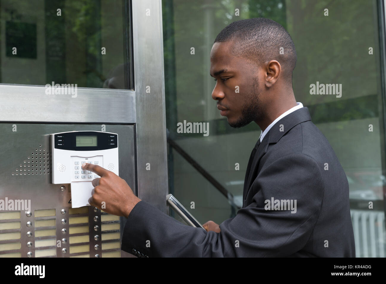 Businessman Entering Code In Security System Stock Photo - Alamy