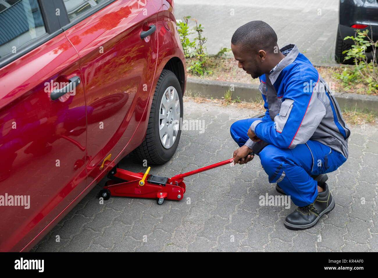 Mechanic Putting Hydraulic Floor Jack Inside The Car Stock Photo - Alamy