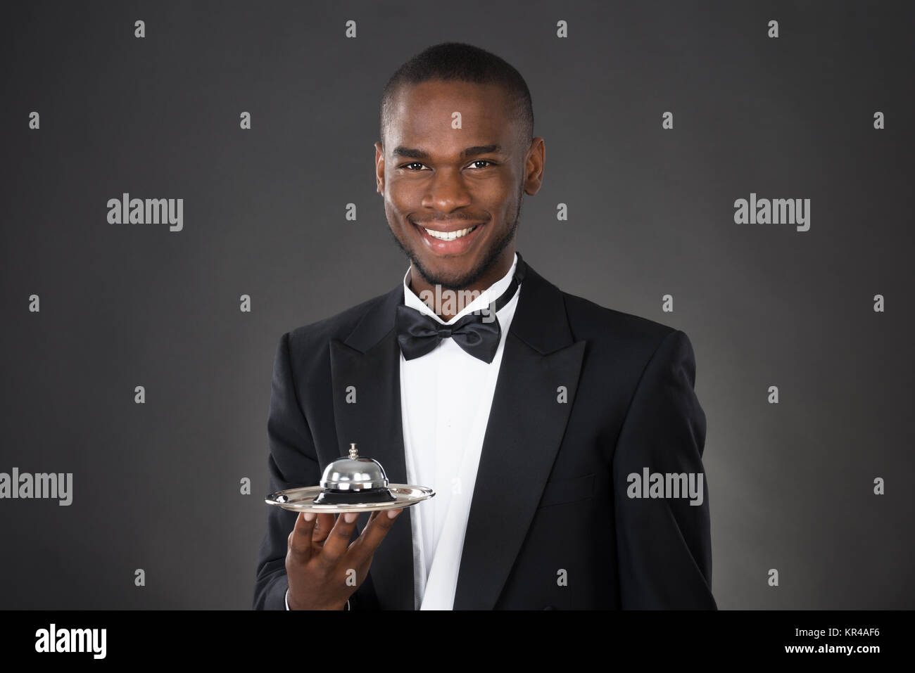 African Waiter Holding Service Bell Stock Photo - Alamy