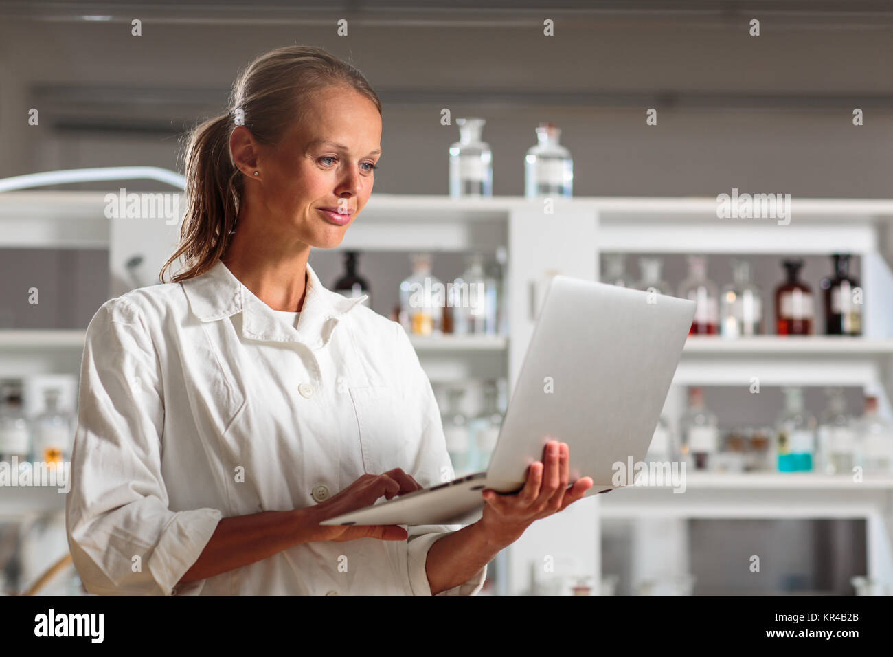 Portrait of a female researcher doing research in a biochemistry lab ...