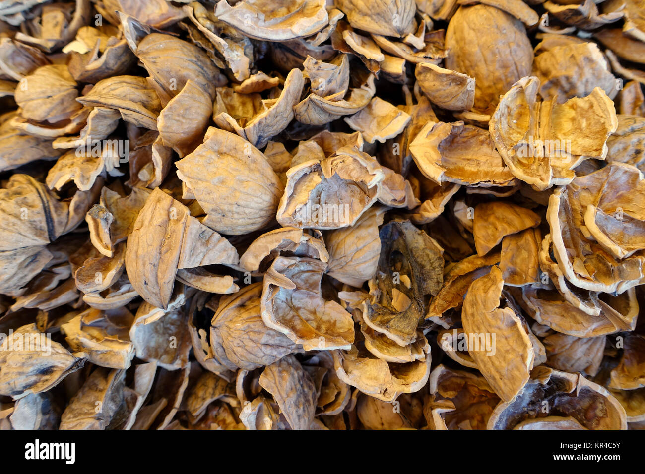 Background of lots of broken walnut shells Stock Photo - Alamy