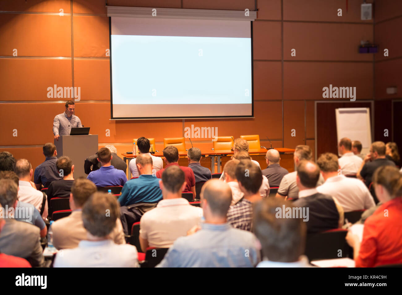 Business speaker giving a talk in conference hall Stock Photo - Alamy