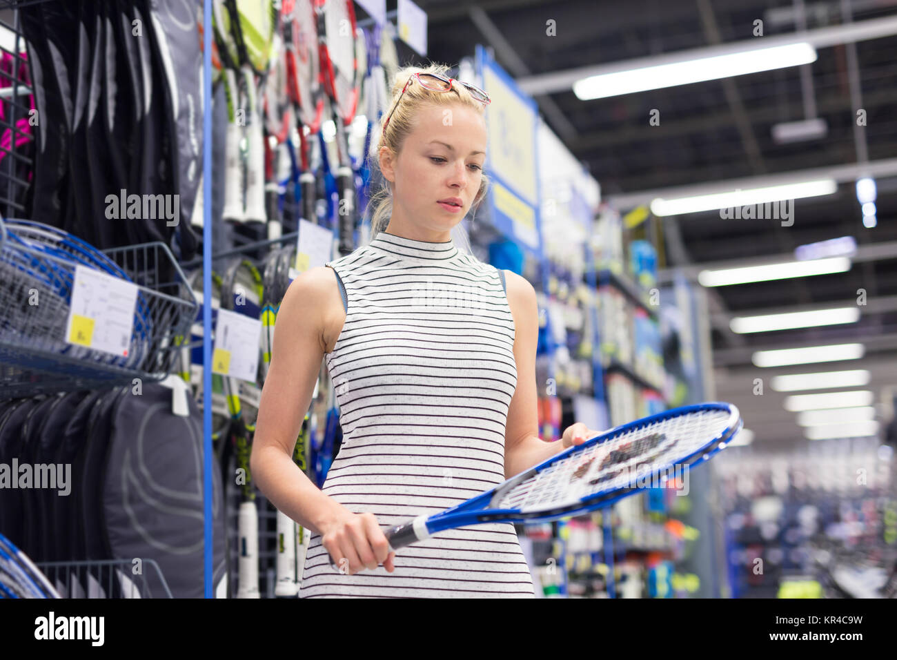 Woman shopping sports equipment in sportswear store Stock Photo - Alamy