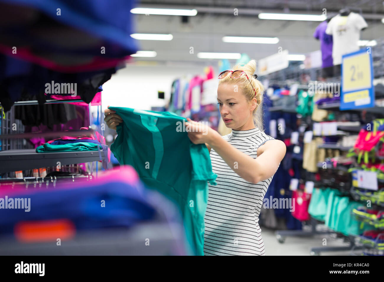 Woman shopping sportswear in sports store Stock Photo - Alamy