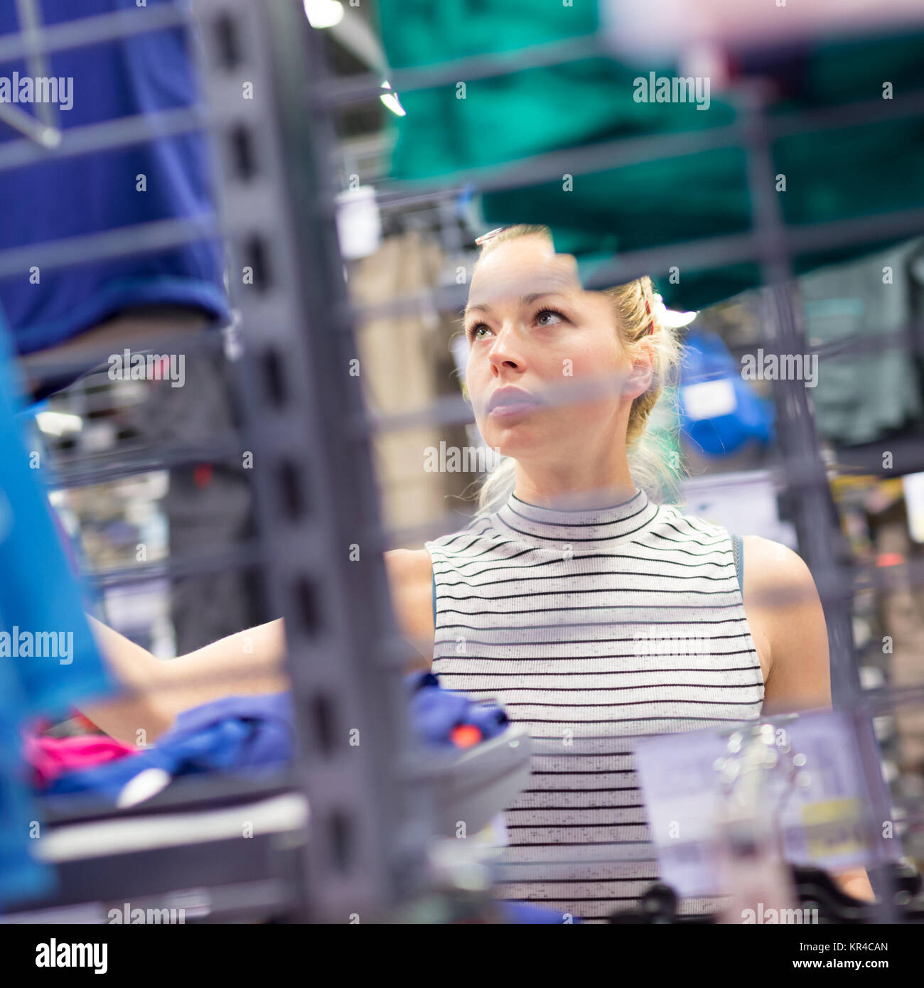 Woman shopping sportswear in sports store Stock Photo - Alamy