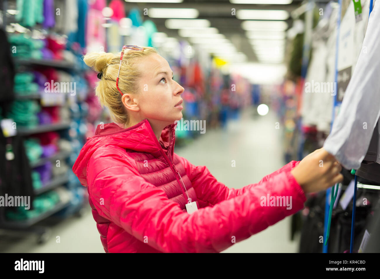Woman shopping sportswear in sports store Stock Photo - Alamy