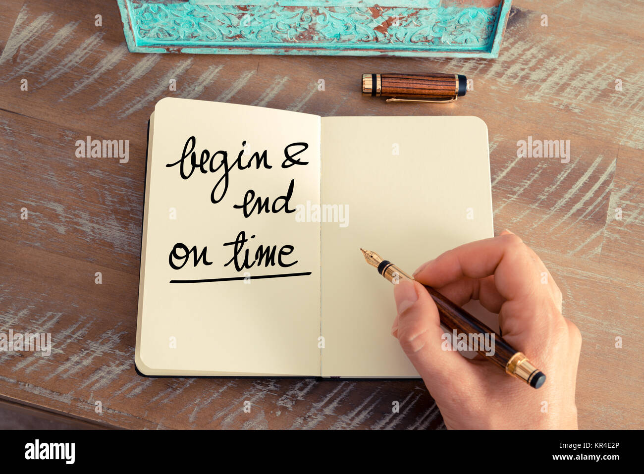 Handwritten text Begin and End On Time Stock Photo - Alamy