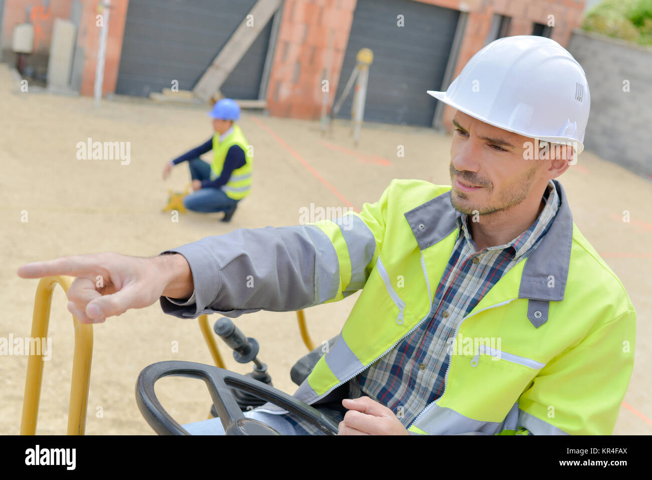 Man driving a digger Stock Photo - Alamy