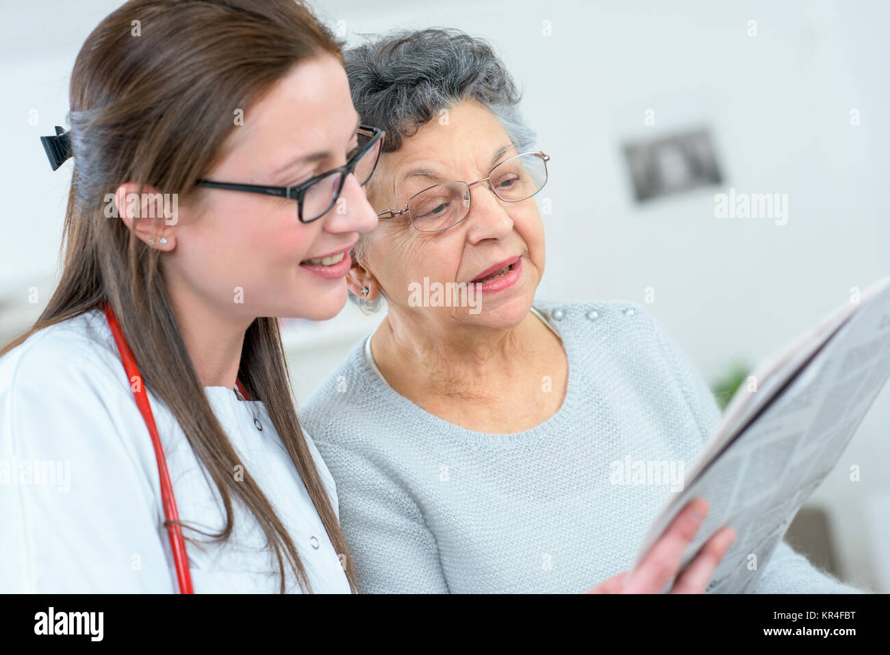 Doctor reading to a patient Stock Photo - Alamy