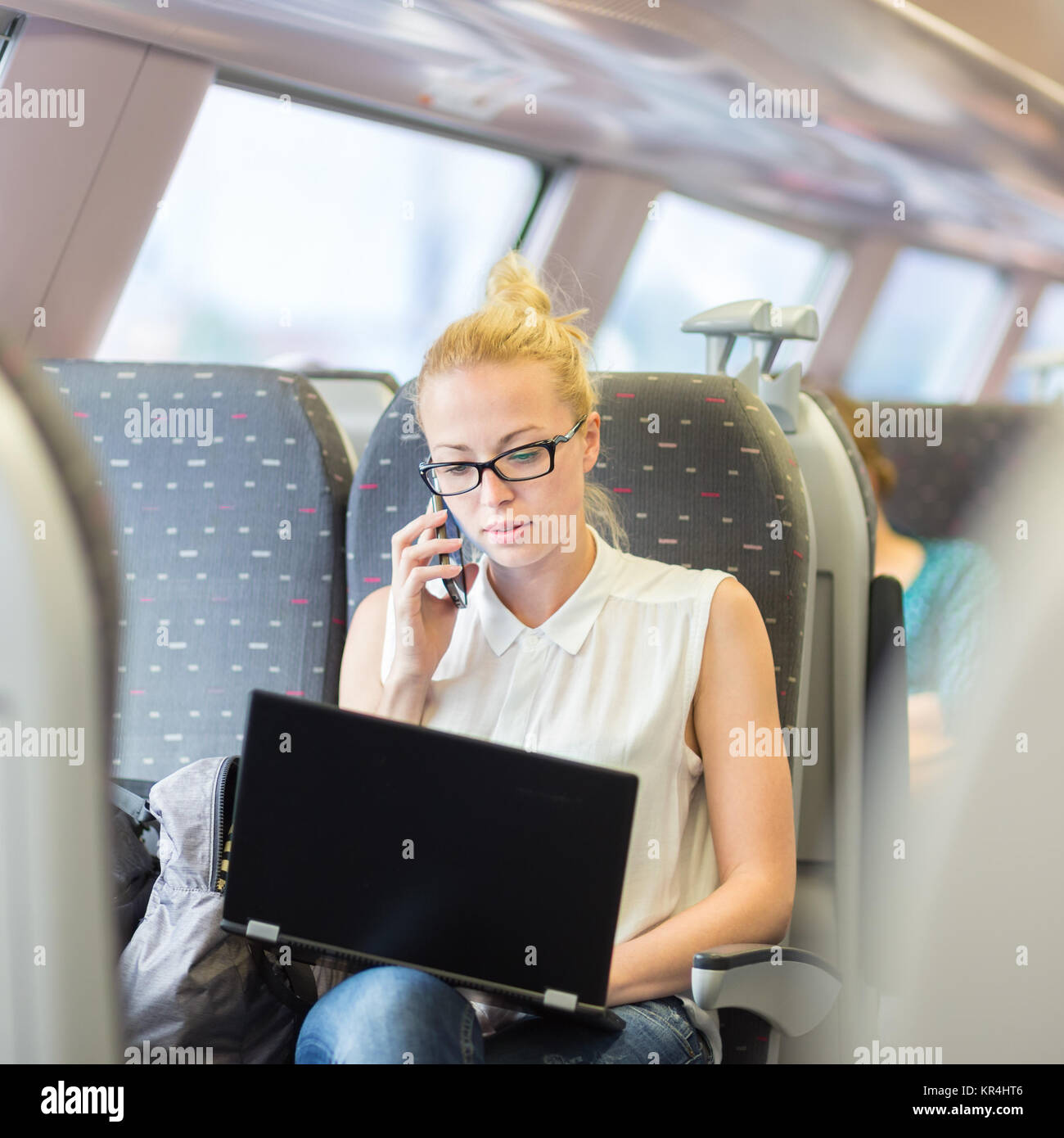 Business woman working while travelling by train Stock Photo - Alamy