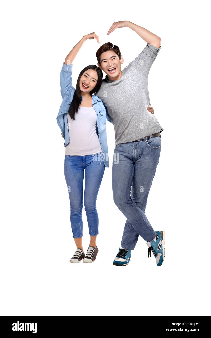 Portrait of asian couple making heart shape with hands posing isolated ...