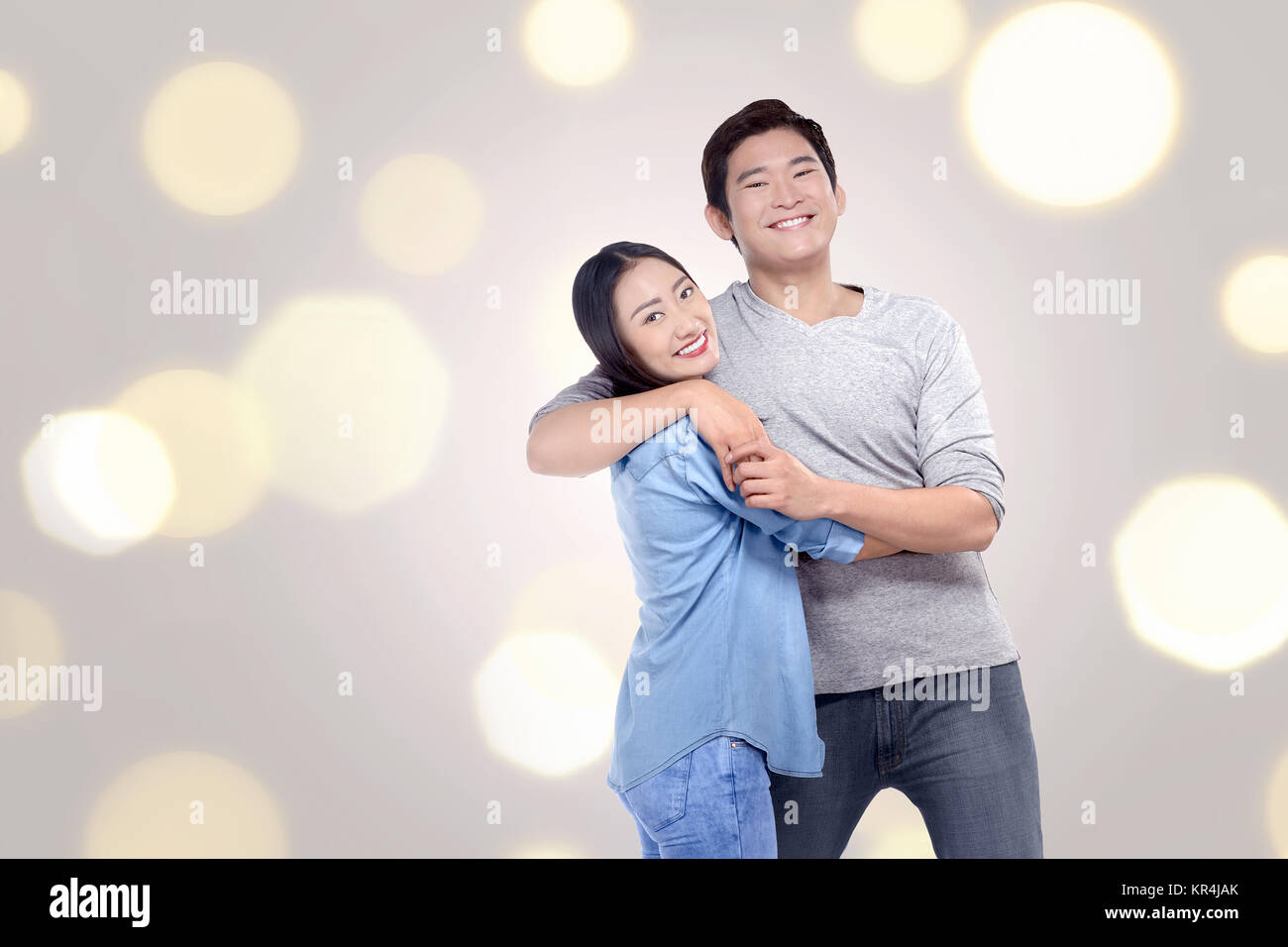 Happy asian couple hugging each other on blur background Stock Photo ...