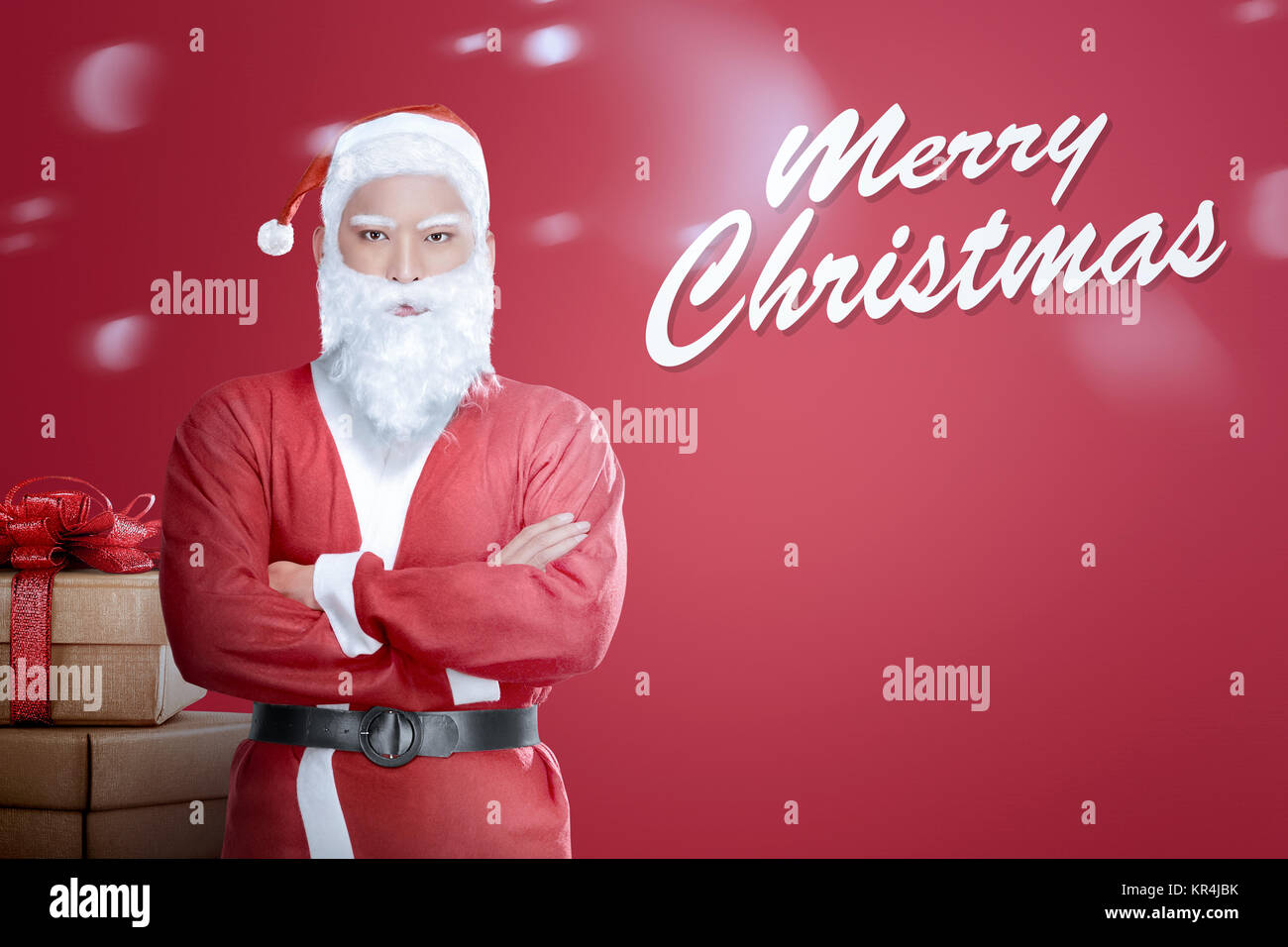 Young asian Santa Claus with Christmas present over red background ...