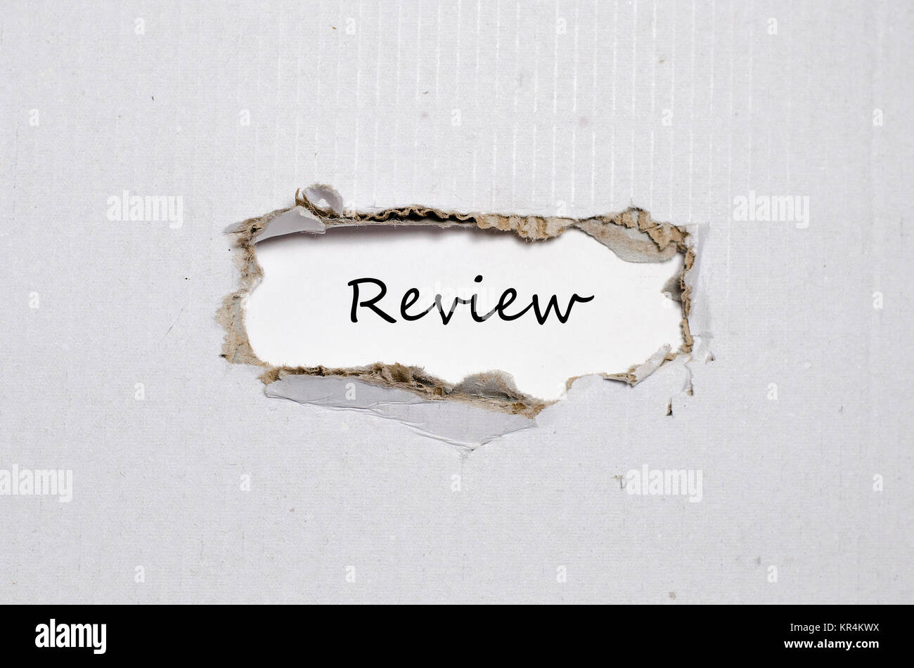 The word review appearing behind torn paper Stock Photo - Alamy