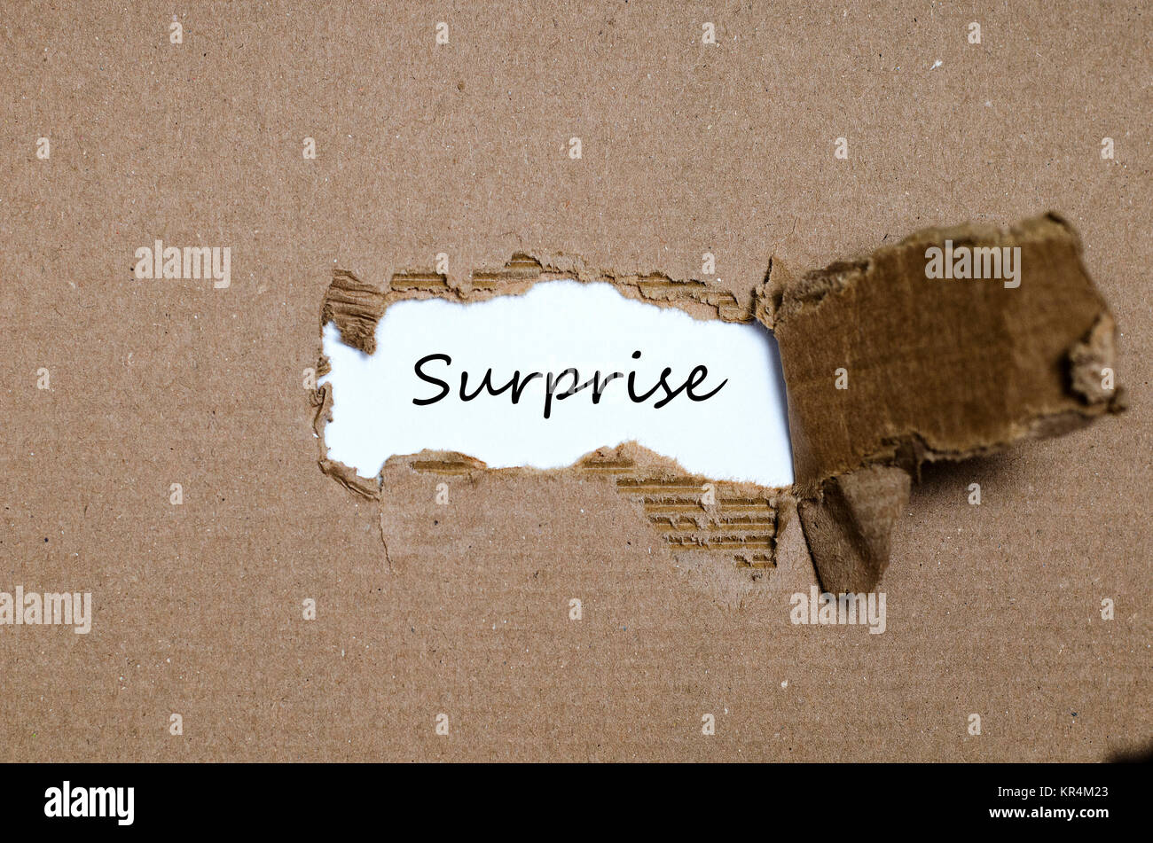 The word surprise appearing behind torn paper Stock Photo - Alamy