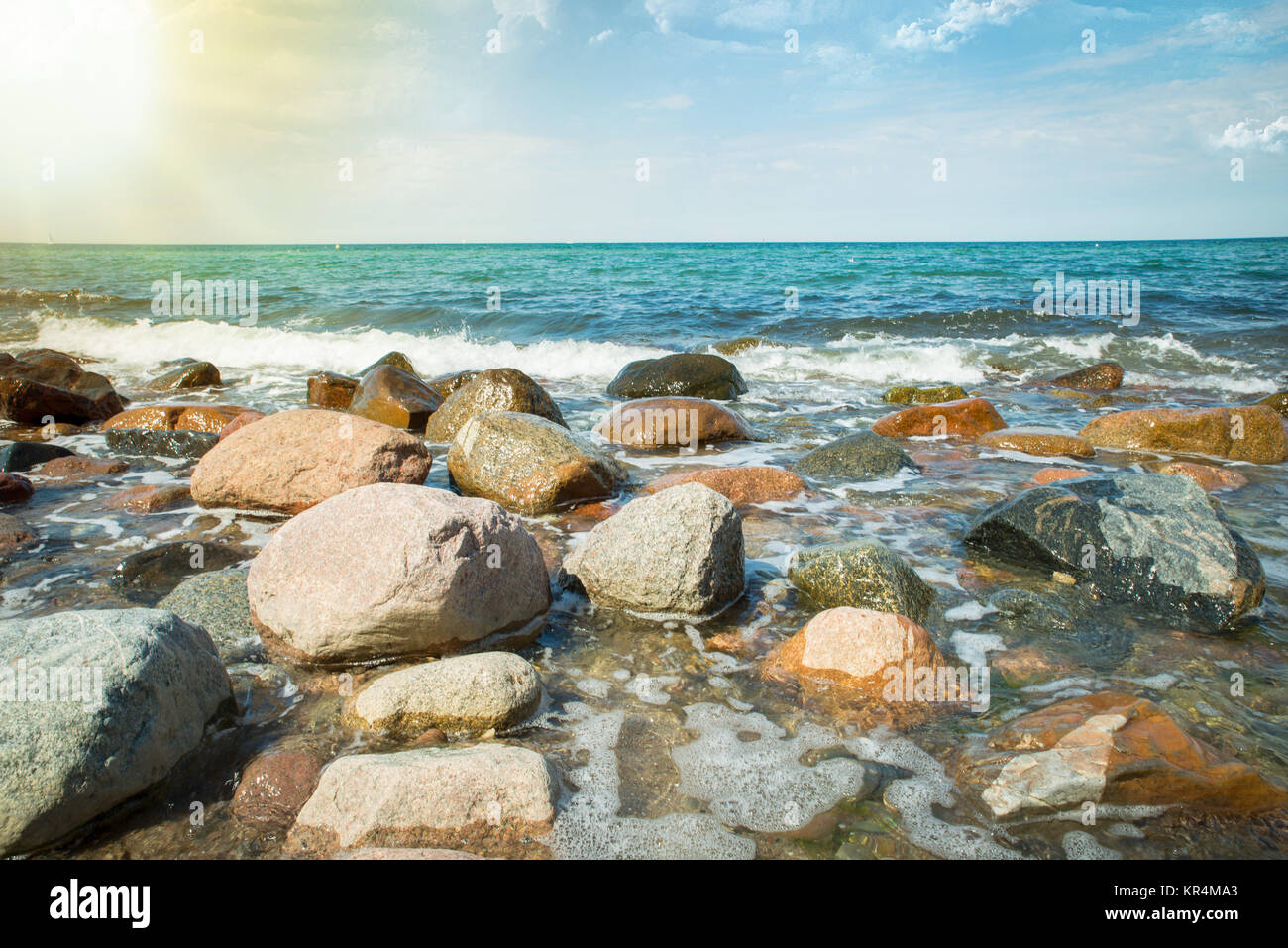 Waves break at the stones Stock Photo - Alamy