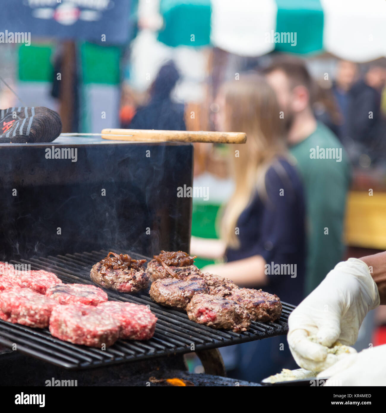 Beef burgers being grilled on food stall grill Stock Photo - Alamy
