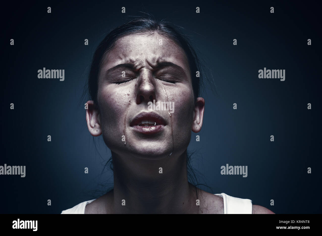 Close up portrait of a crying woman with bruised skin and black eyes ...