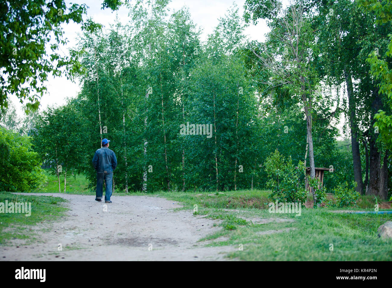 Homeless man walking in park Stock Photo - Alamy