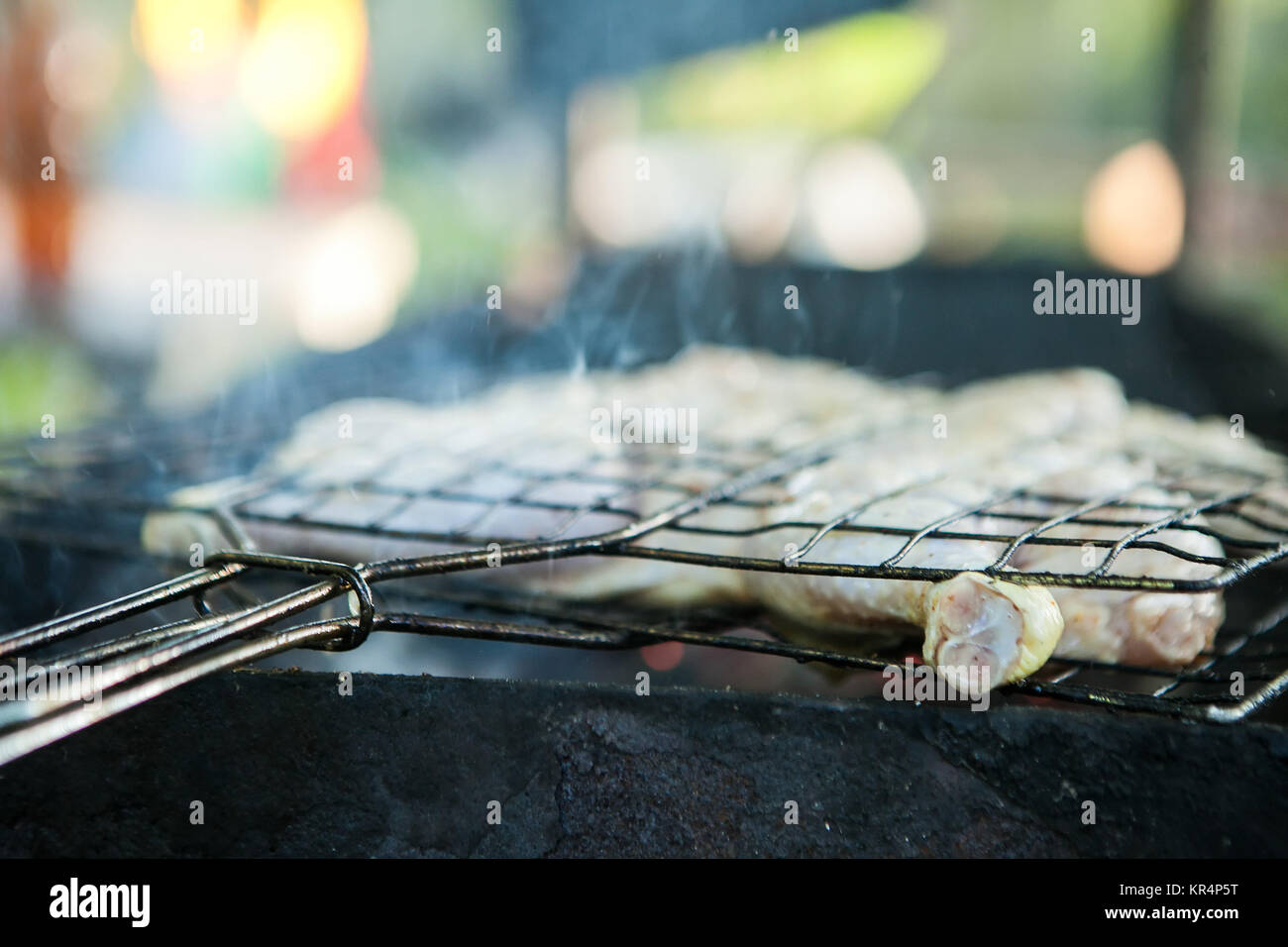 Process of cooking raw spicy chicken fillet on grill Stock Photo - Alamy