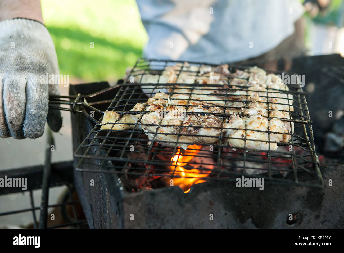 Chicken on barbecue grill with fire Stock Photo - Alamy