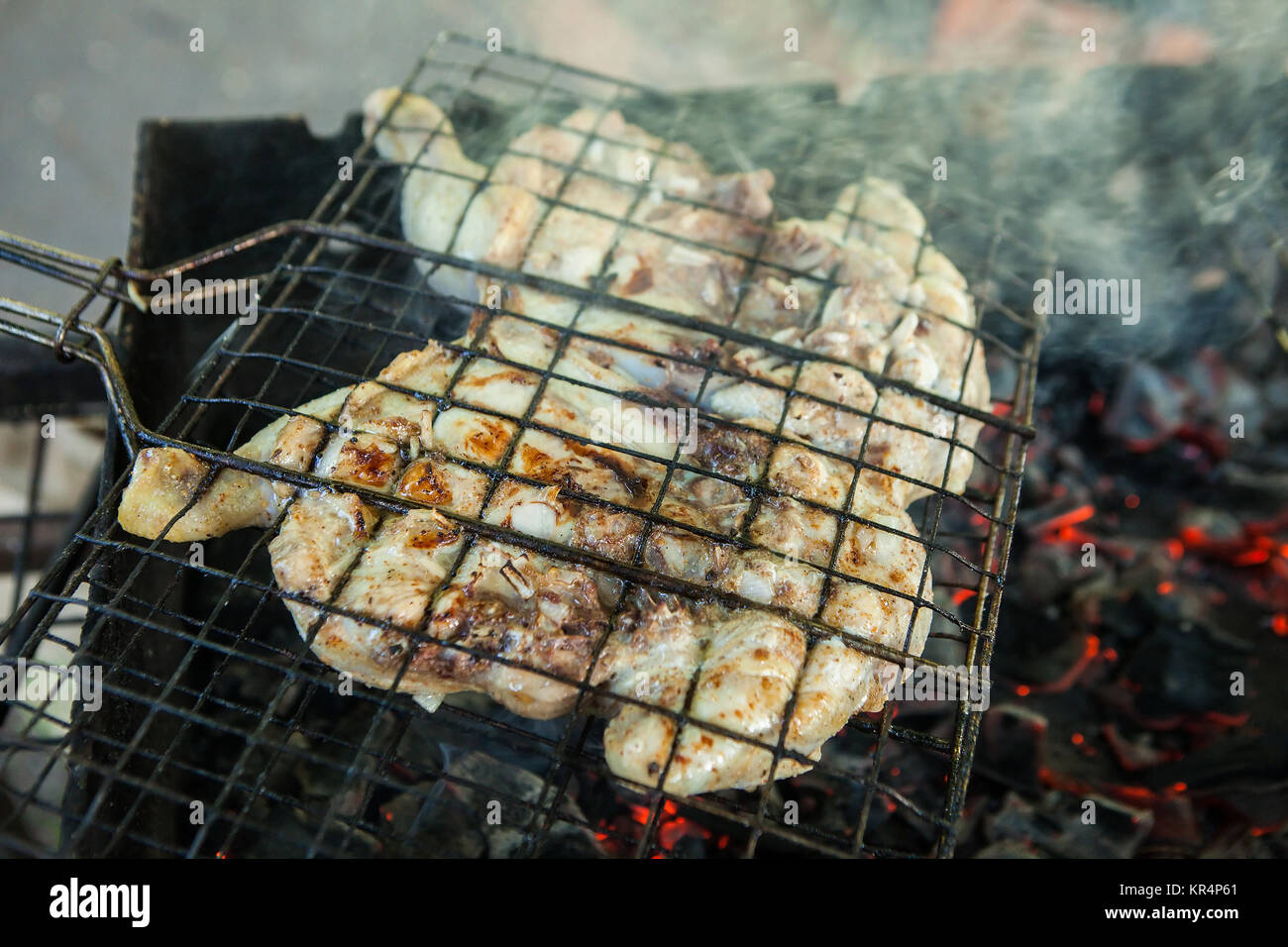 Roast chicken on grill. Fried chicken on the barbecue grill cooked on ...