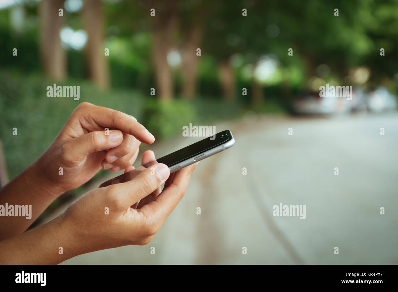 close up hand using phone on street Stock Photo - Alamy