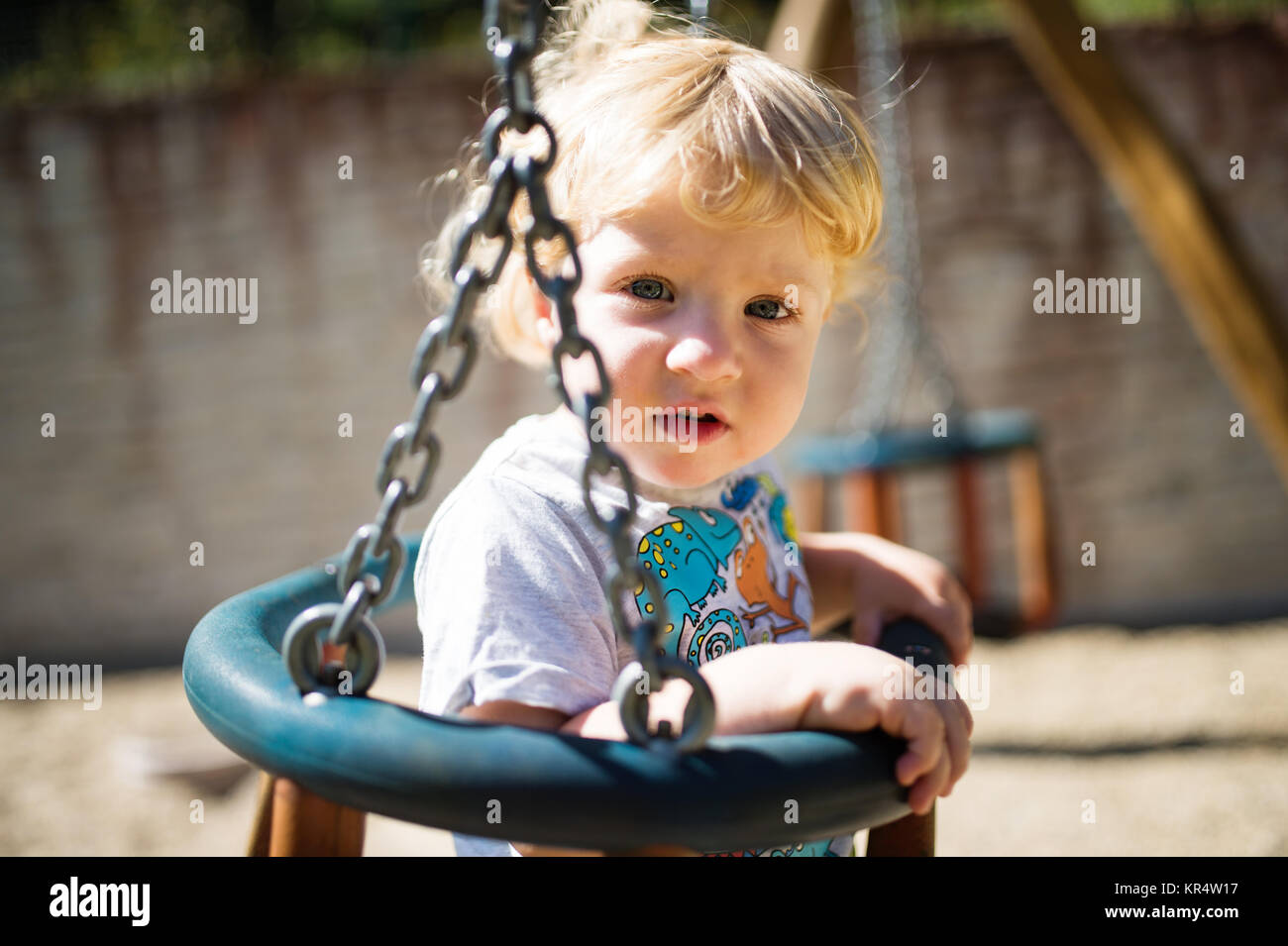 Boy child blond swing playground hi-res stock photography and images - Alamy