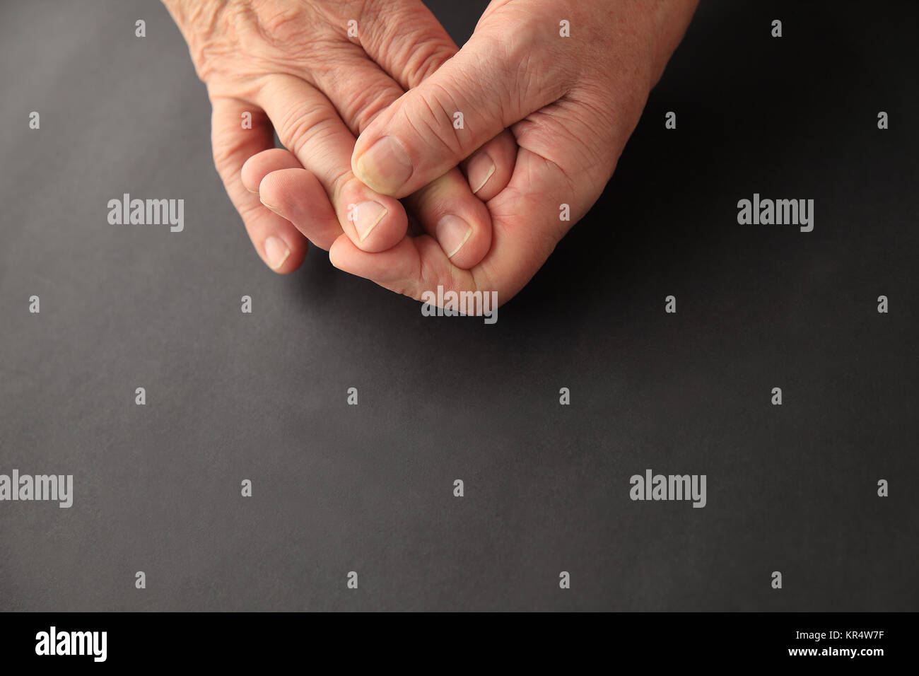 Senior with sore finger, copy space included Stock Photo - Alamy