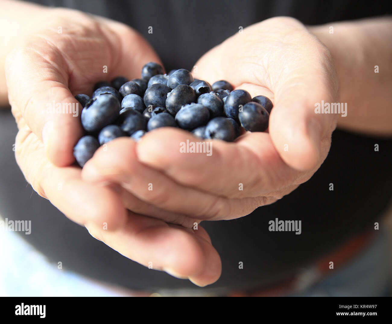 Older man with blueberries Stock Photo - Alamy