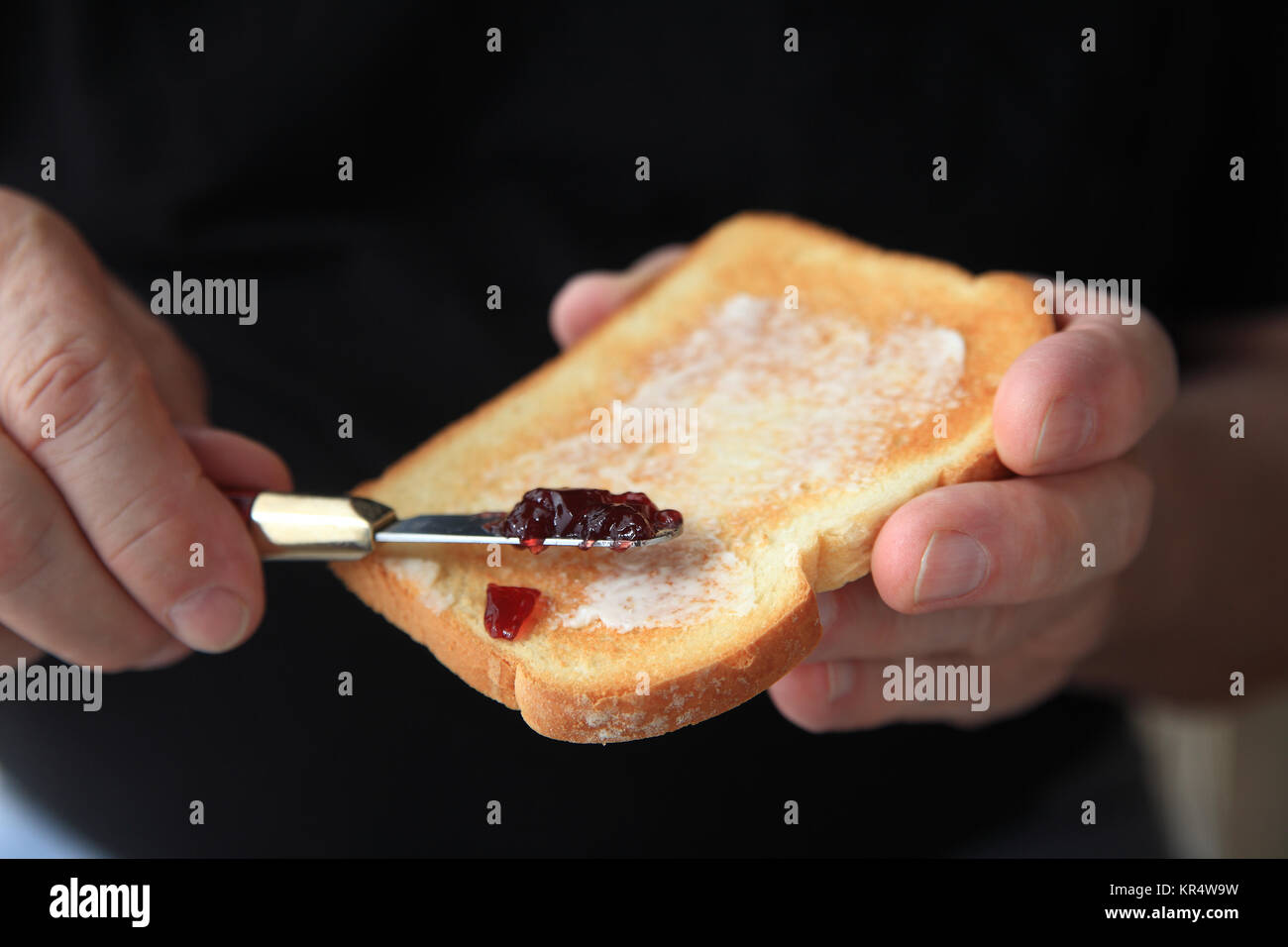 Man prepares buttered toast with jamÂ Stock Photo - Alamy