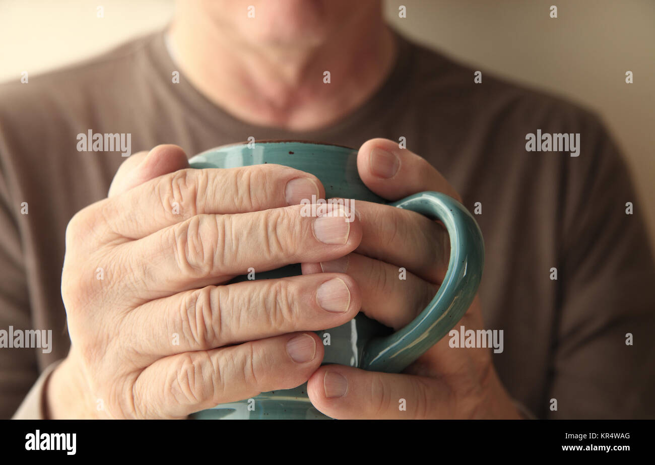 Hands around cup hi-res stock photography and images - Alamy