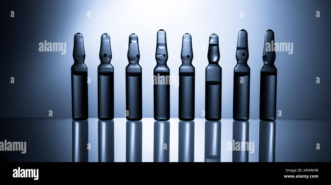 Medical ampules for injection isolated on blue background. Ampoules ...