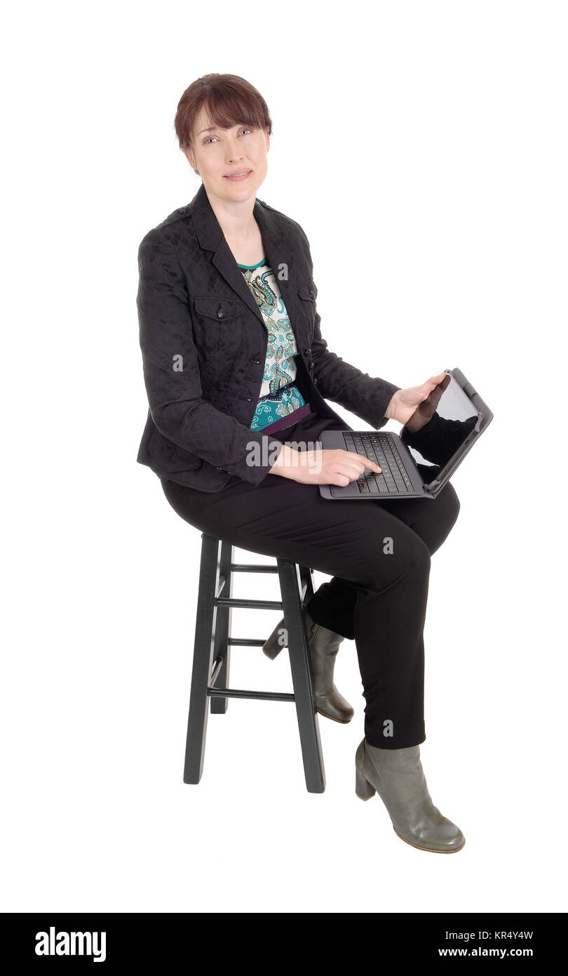 Woman sitting with a laptop on her lap Stock Photo - Alamy