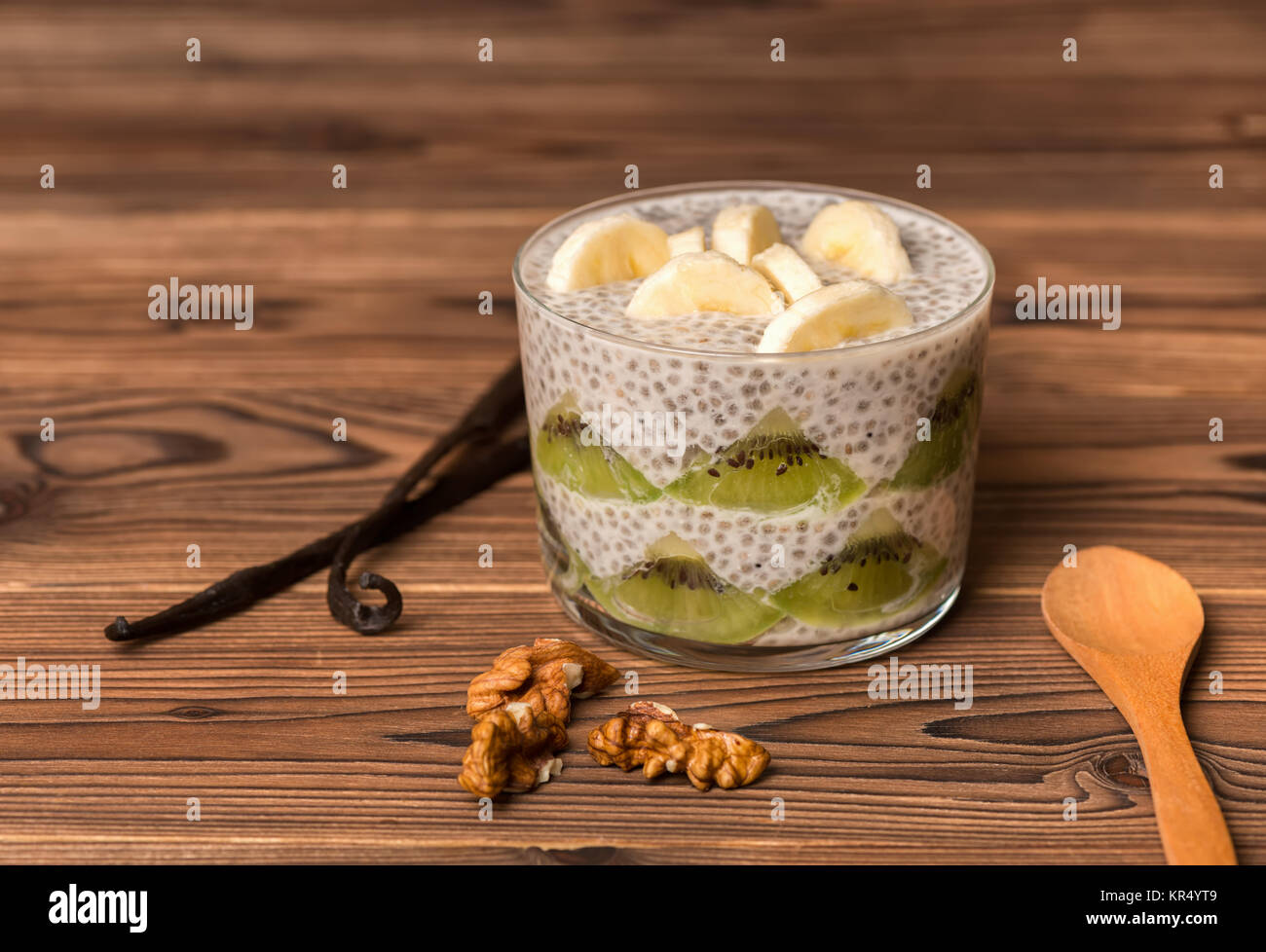 chia seed pudding in glass cup made with bananas, kiwi, decorated ...