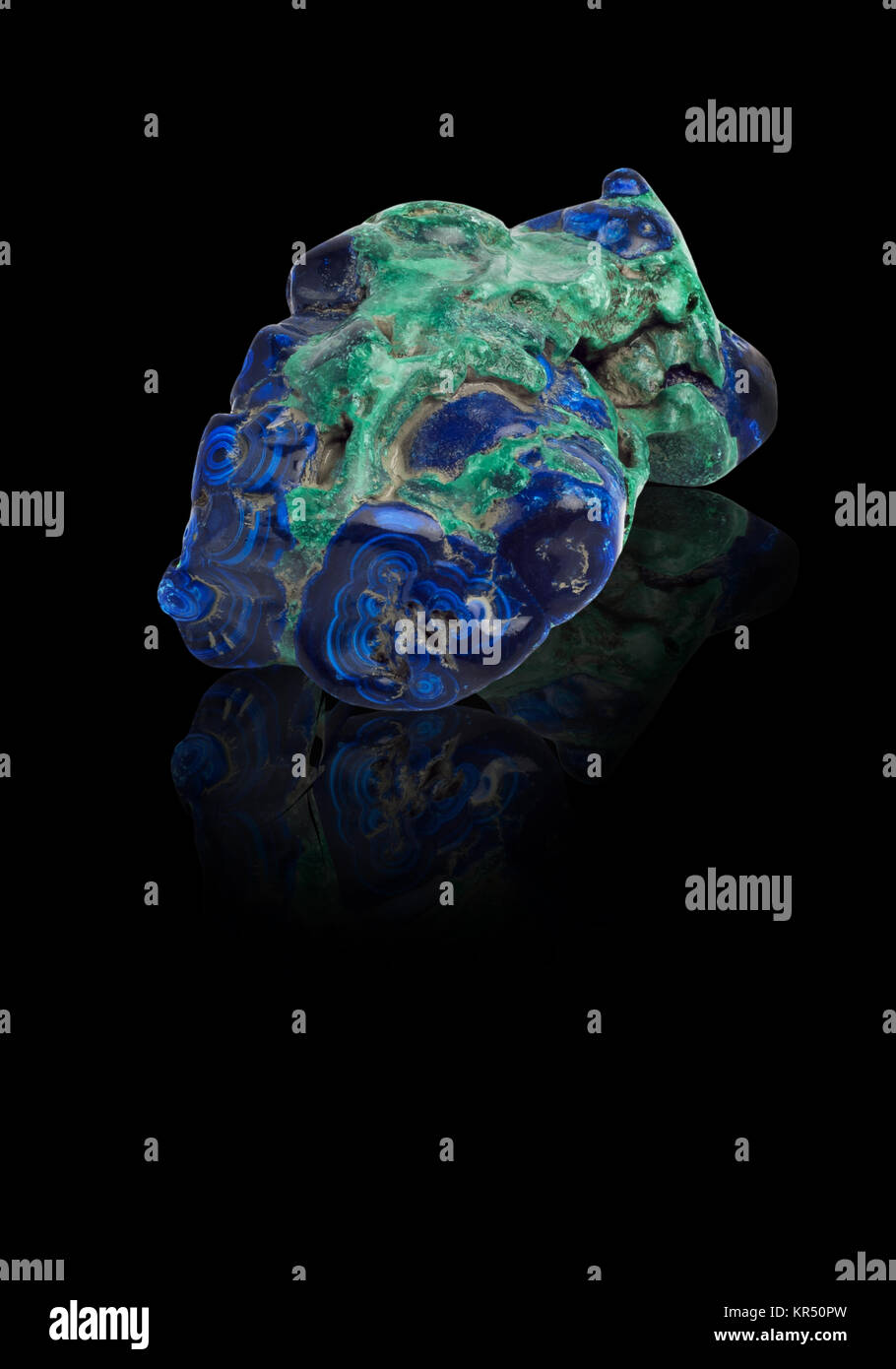 Blue and green Azurite gemstone with ground reflection on the black ...