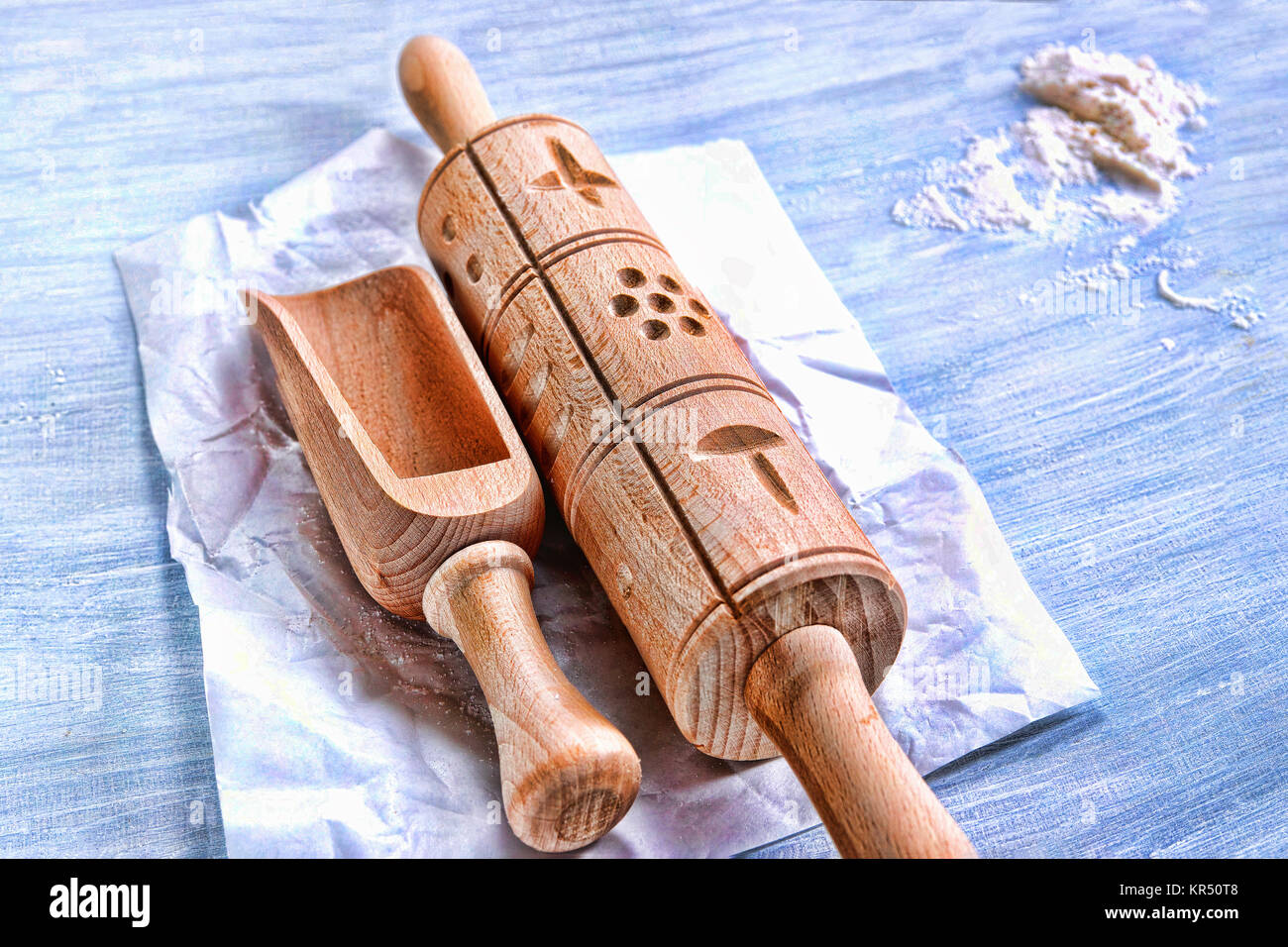 Roll of dough and scoop on a floured board Stock Photo - Alamy