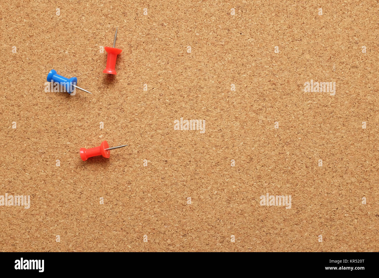 Three push pins on a cork noticeboard Stock Photo - Alamy