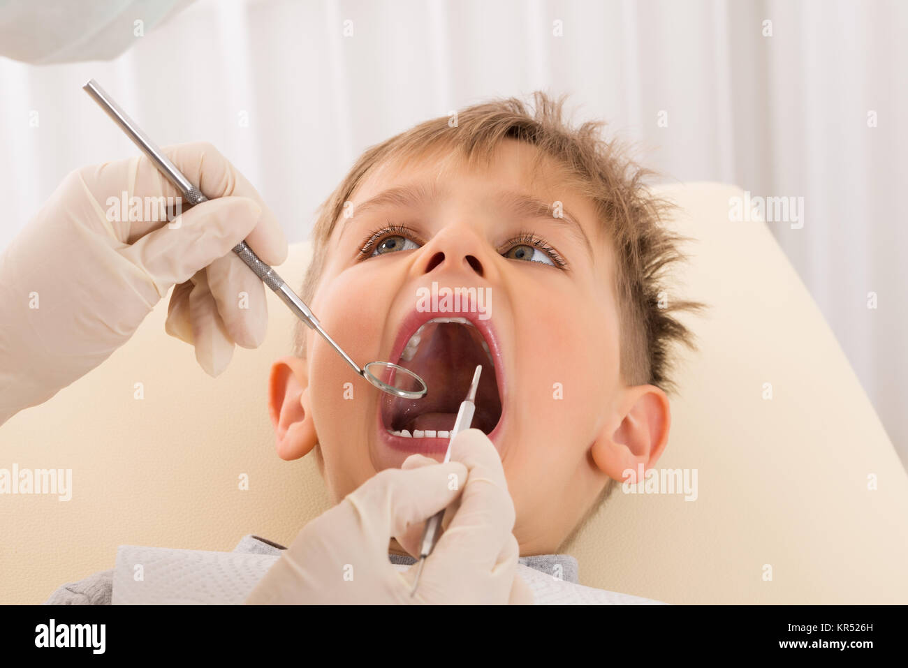 Dentist's Hand Examining Teeth Of Child Patient Stock Photo - Alamy