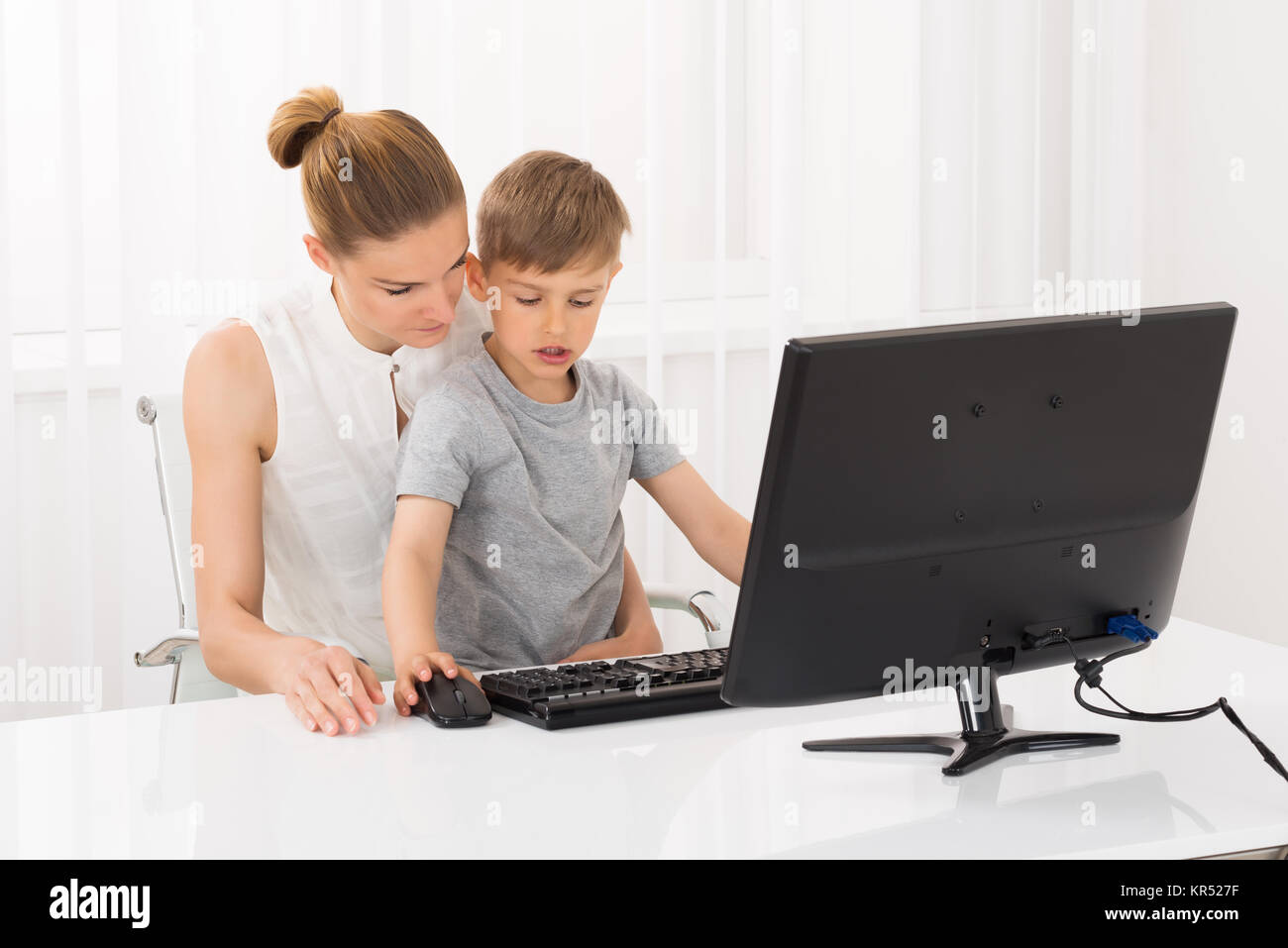 Mother And Son Using Computer Stock Photo - Alamy